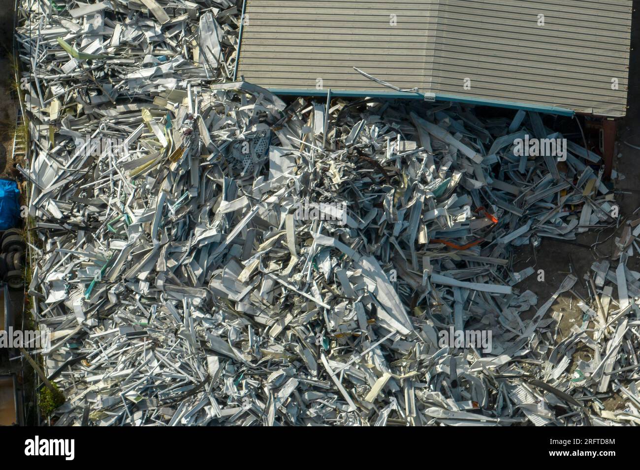 Aerial view of large pile of scrap aluminum metal from broken houses ...