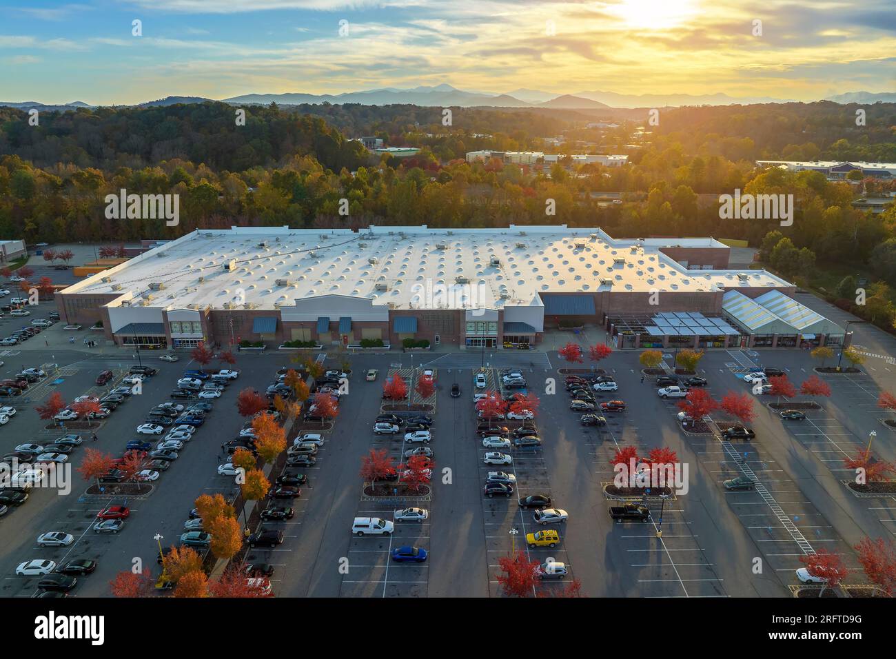 Aerial view of large parking lot in front of rgocery store with many ...