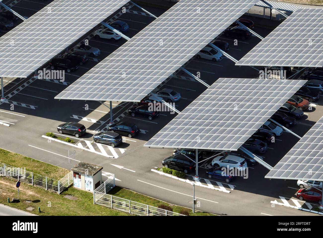 Aerial view of solar panels installed over parking lot with parked cars ...