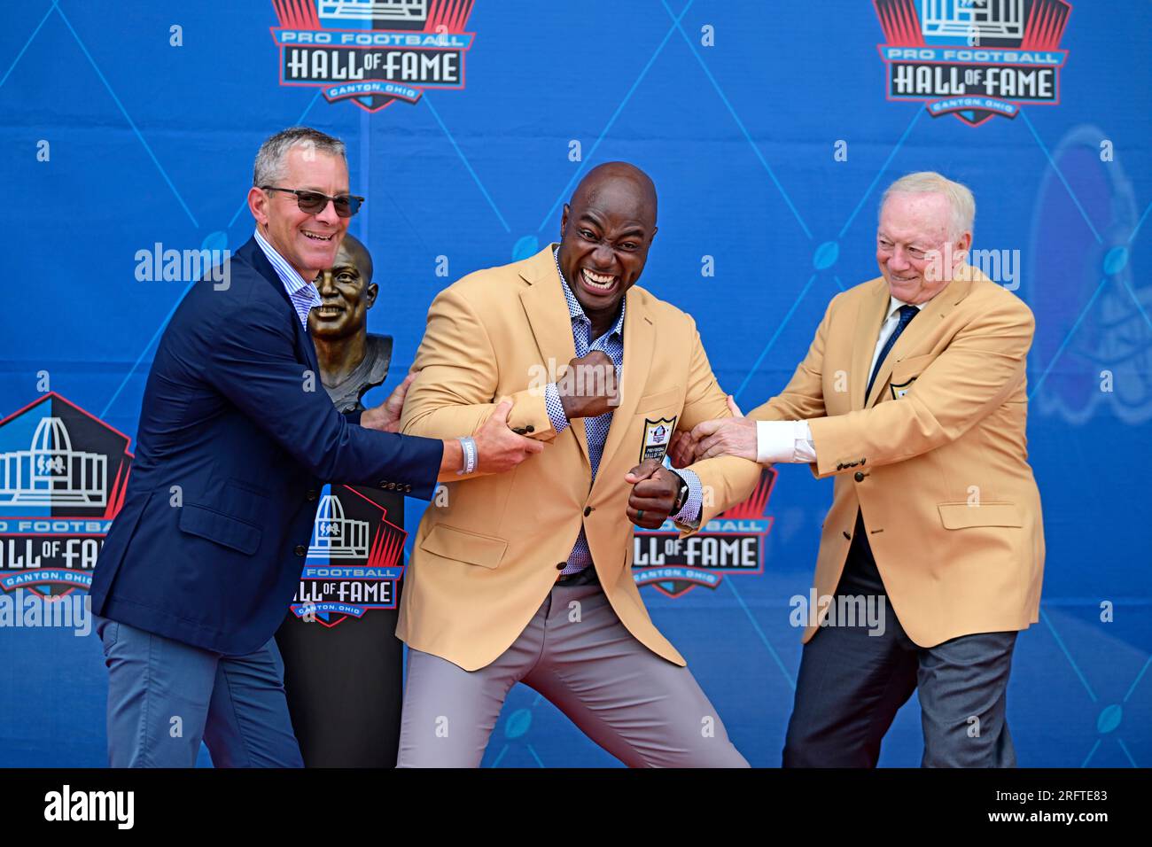 Former NFL player DeMarcus Ware, center, shares a laugh as Greg Penner ...