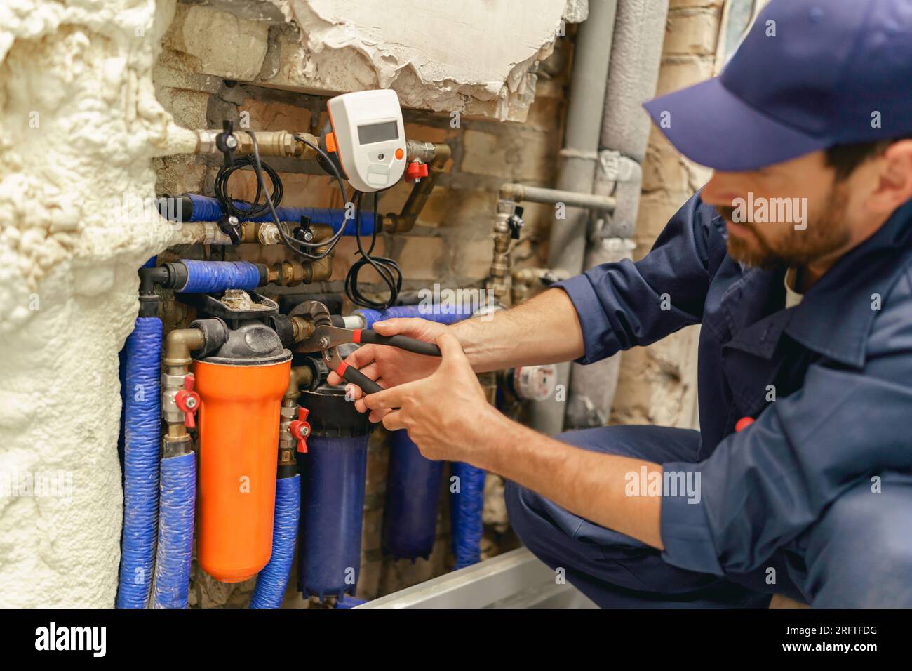 Professional plumber repairing water supply system at home uses an ...