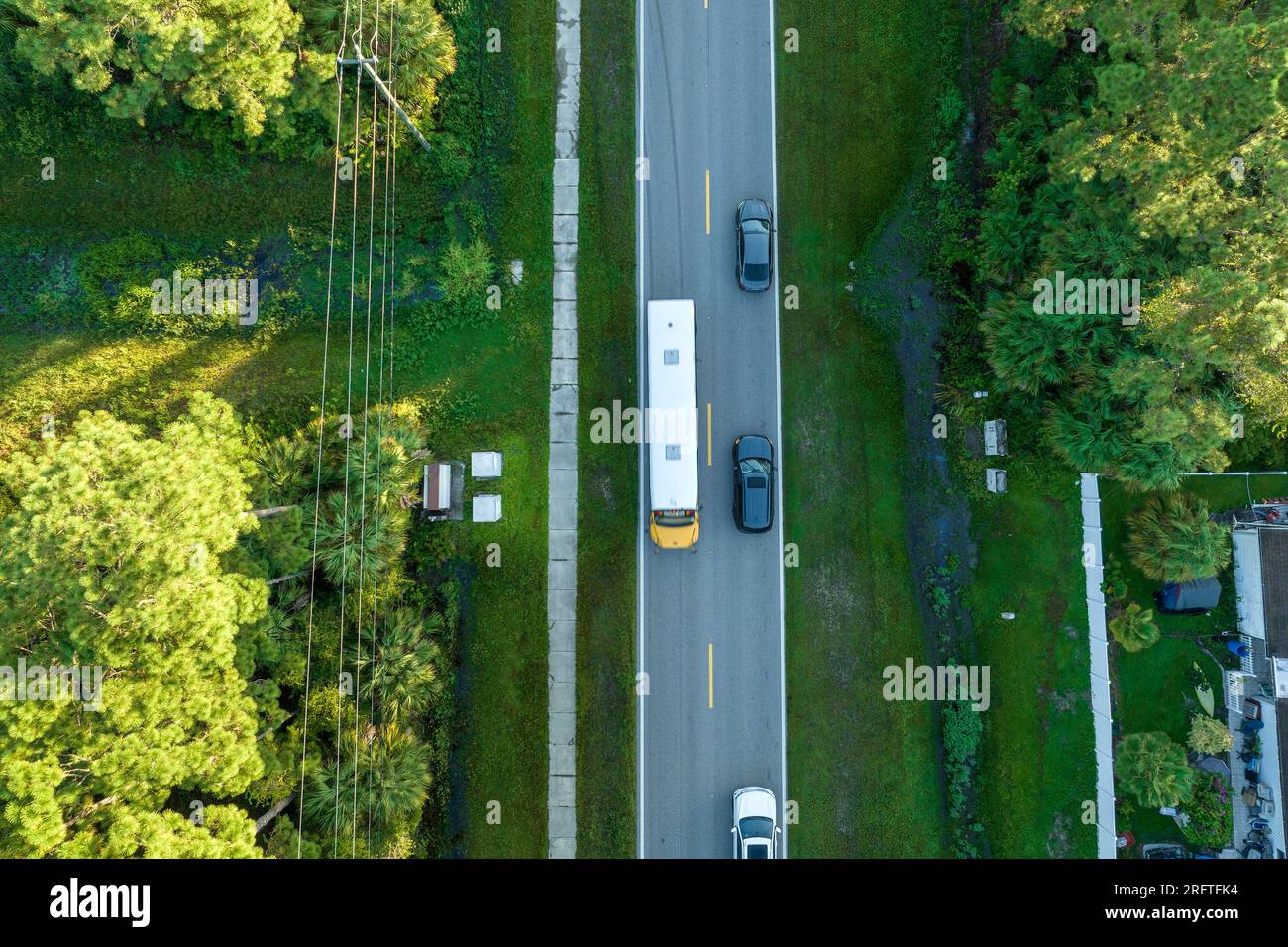 Top view of classical american yellow school bus driving on rural town ...