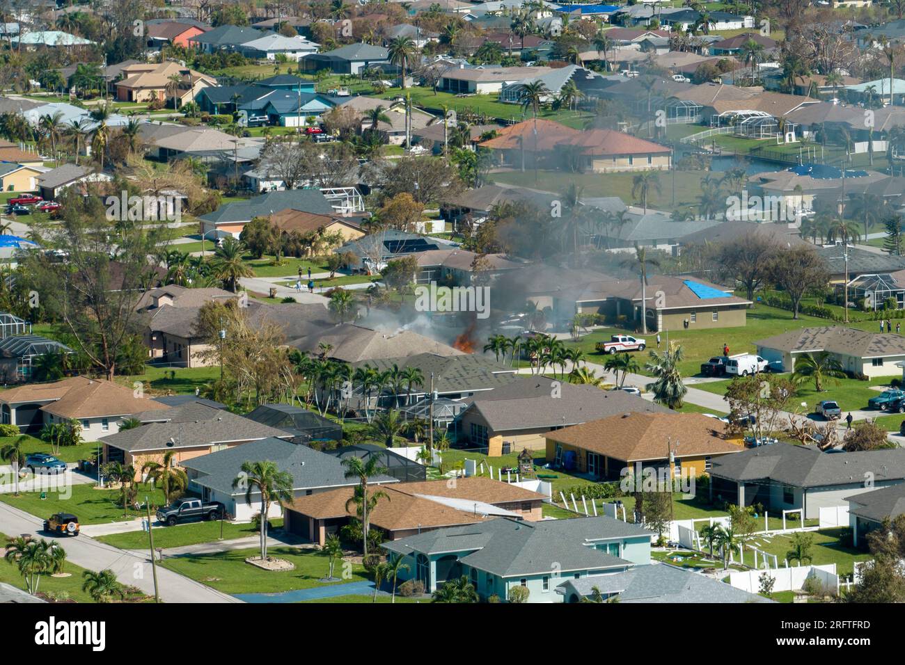 View from above of burning private house on fire and firefighters ...