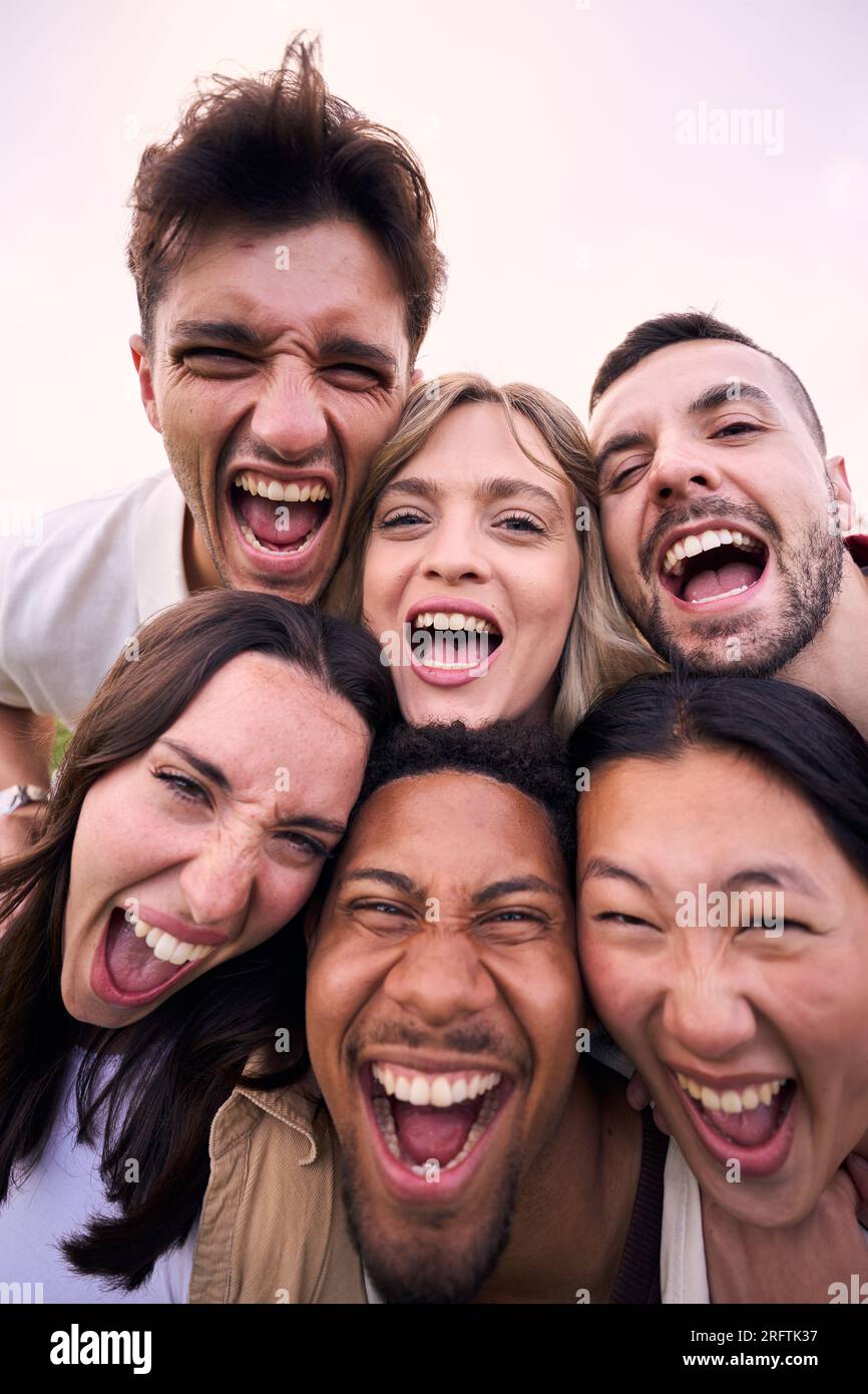 Vertical portrait multiracial friends excited outdoors. Group diverse ...