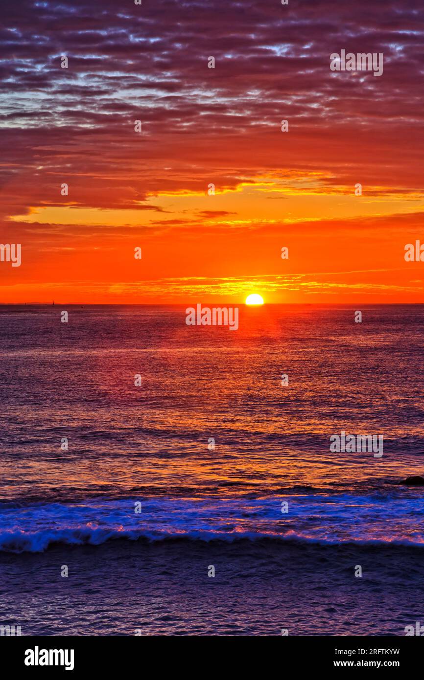 Pacific ocean sea at Nobbys head in Newcastle - rising sun vertical ...