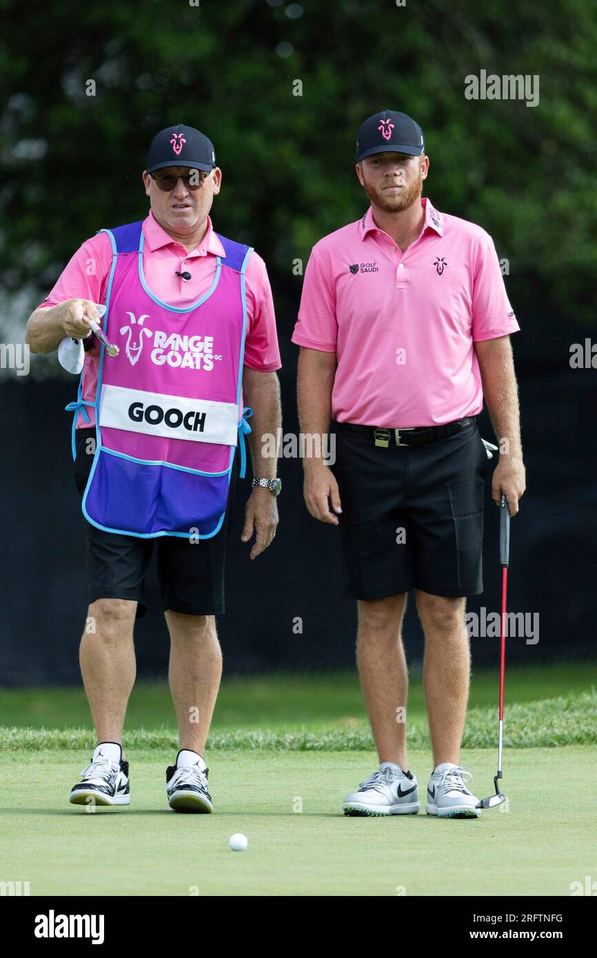 Talor Gooch of RangeGoats GC and his caddie speak on the 16th green ...