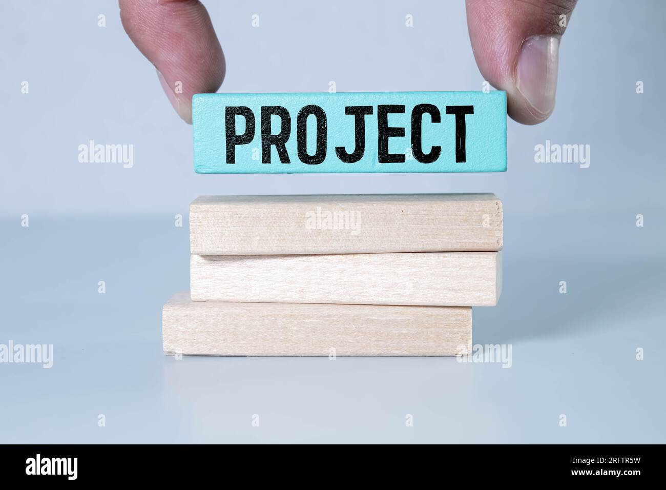 Project word from wooden blocks on gray background Stock Photo - Alamy