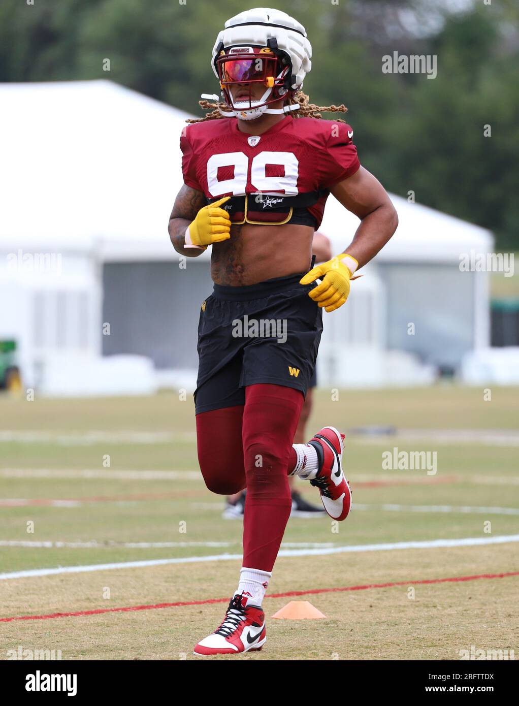Washington Commanders DE Chase Young (99) jogs after running through ...