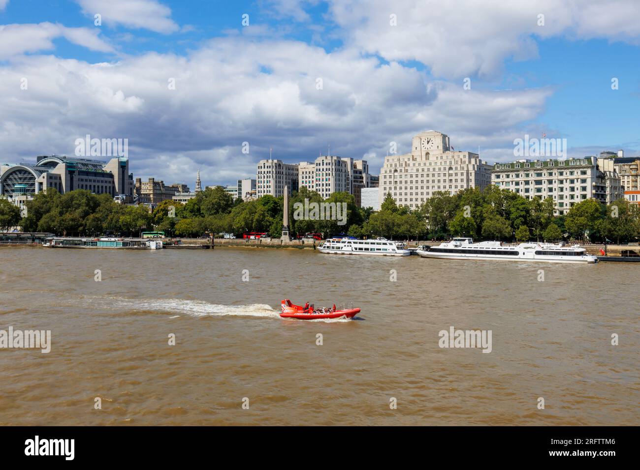 A Thames Rockets RIB sails past Shell Mex House on Victoria Embankment ...