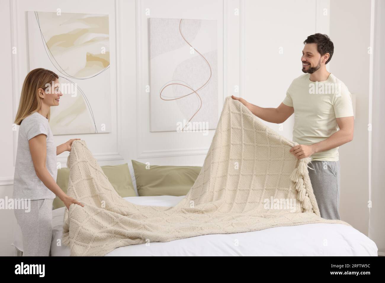 Couple changing bed linens at home. Domestic chores Stock Photo - Alamy