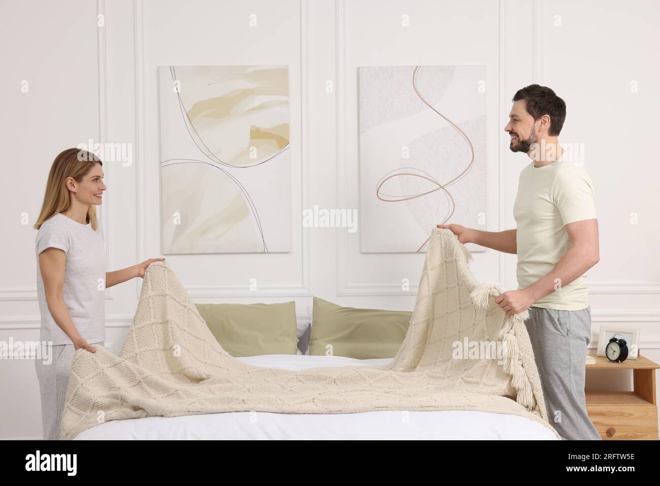 Couple changing bed linens at home. Domestic chores Stock Photo - Alamy