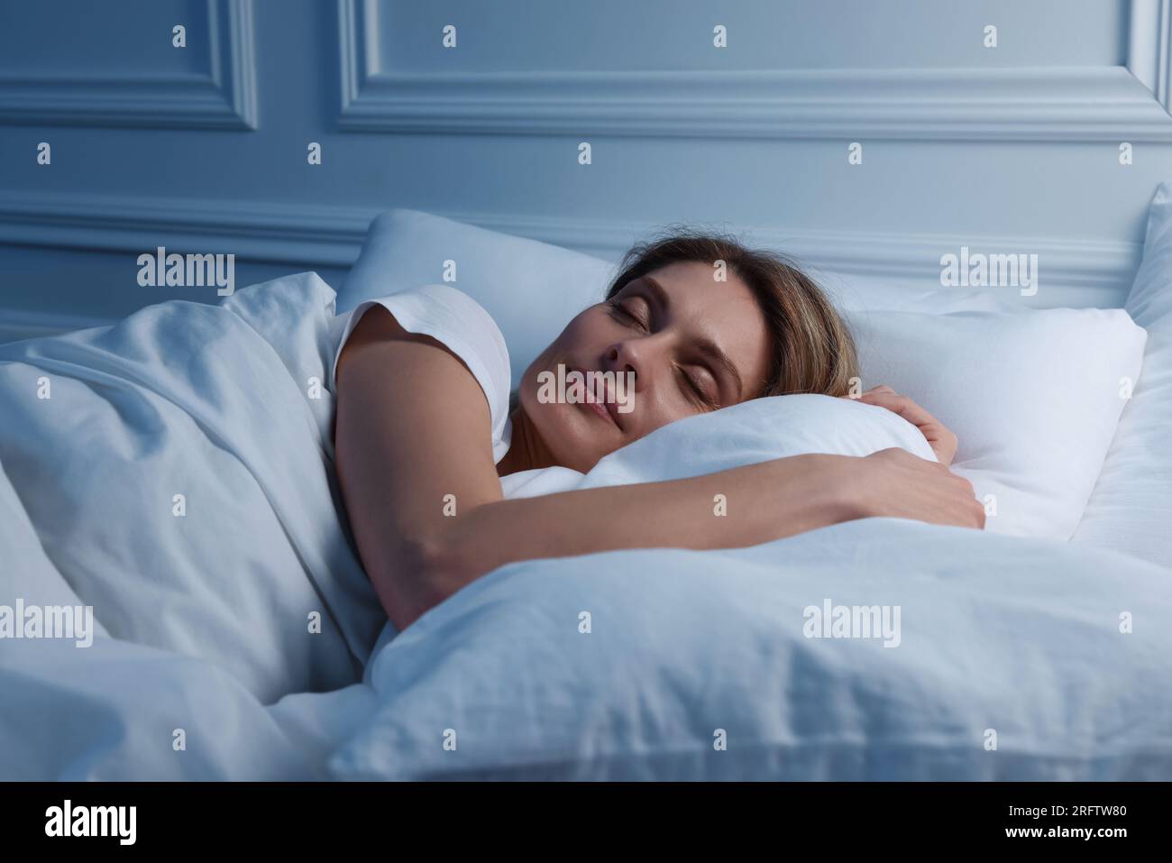 Beautiful woman sleeping in bed at night Stock Photo - Alamy