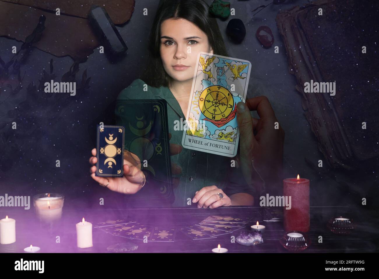 Soothsayer predicting future with tarot cards at table in darkness ...