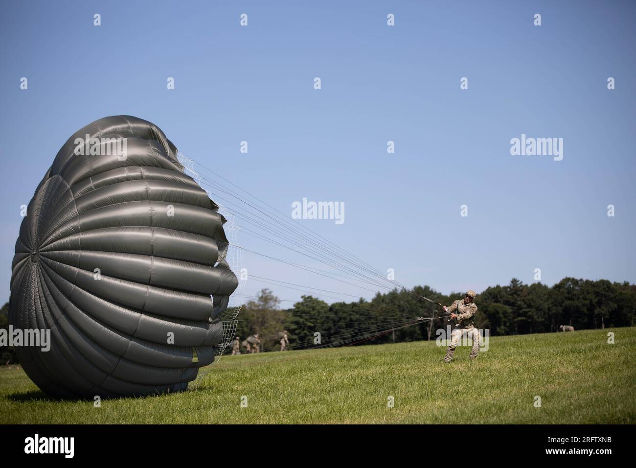 A U.S. Army Paratrooper gains control of his parachute after jumping ...