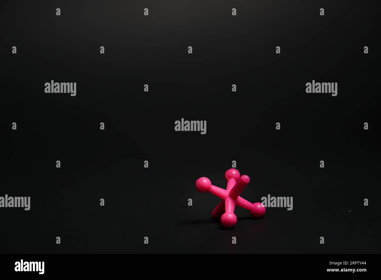 Plastic toy of molecule elements background, pink pastic atom structure ...