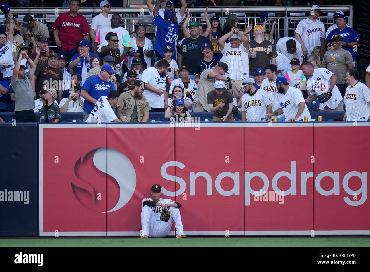 San Diego Padres left fielder Juan Soto sits against the wall after a ...