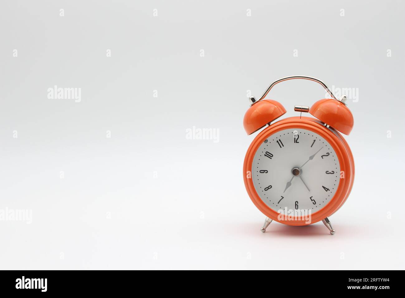 Orange color alarm clock with white background, front view Stock Photo ...