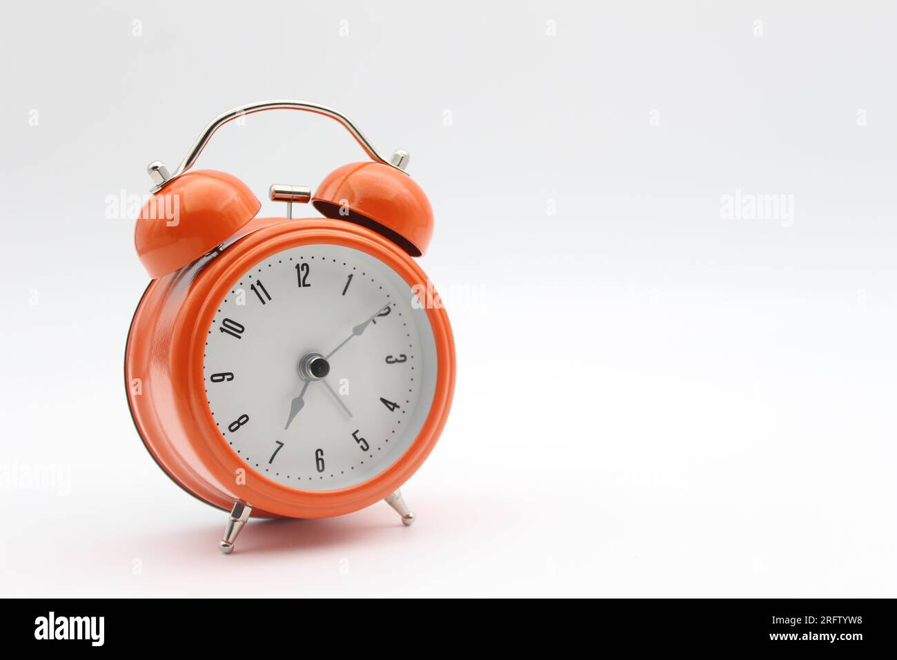 Orange color alarm clock with white background, front view Stock Photo ...
