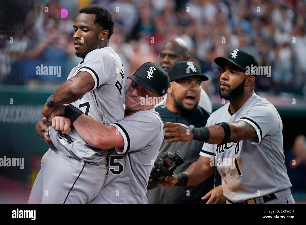 Chicago White Sox's Tim Anderson (7) is held by Andrew Vaughn, center ...