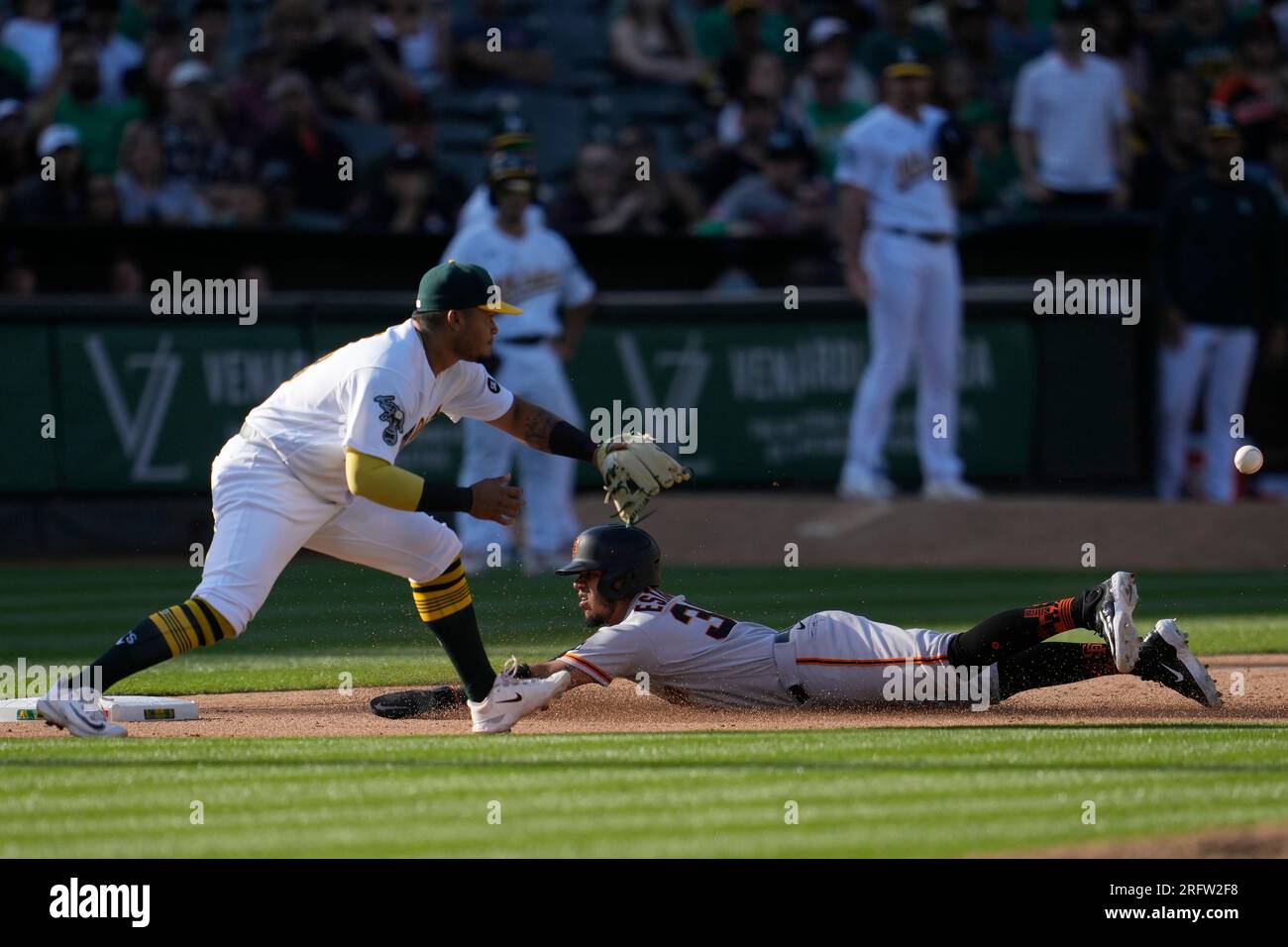 San Francisco Giants' Thairo Estrada, right, slides safely into third ...