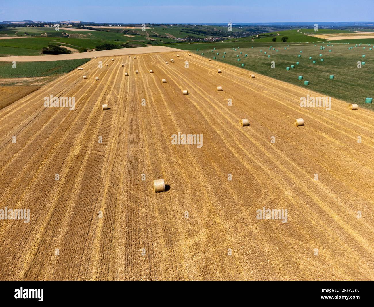 Aerial view, agriculture in France, yellow haystacks on golden wheat ...