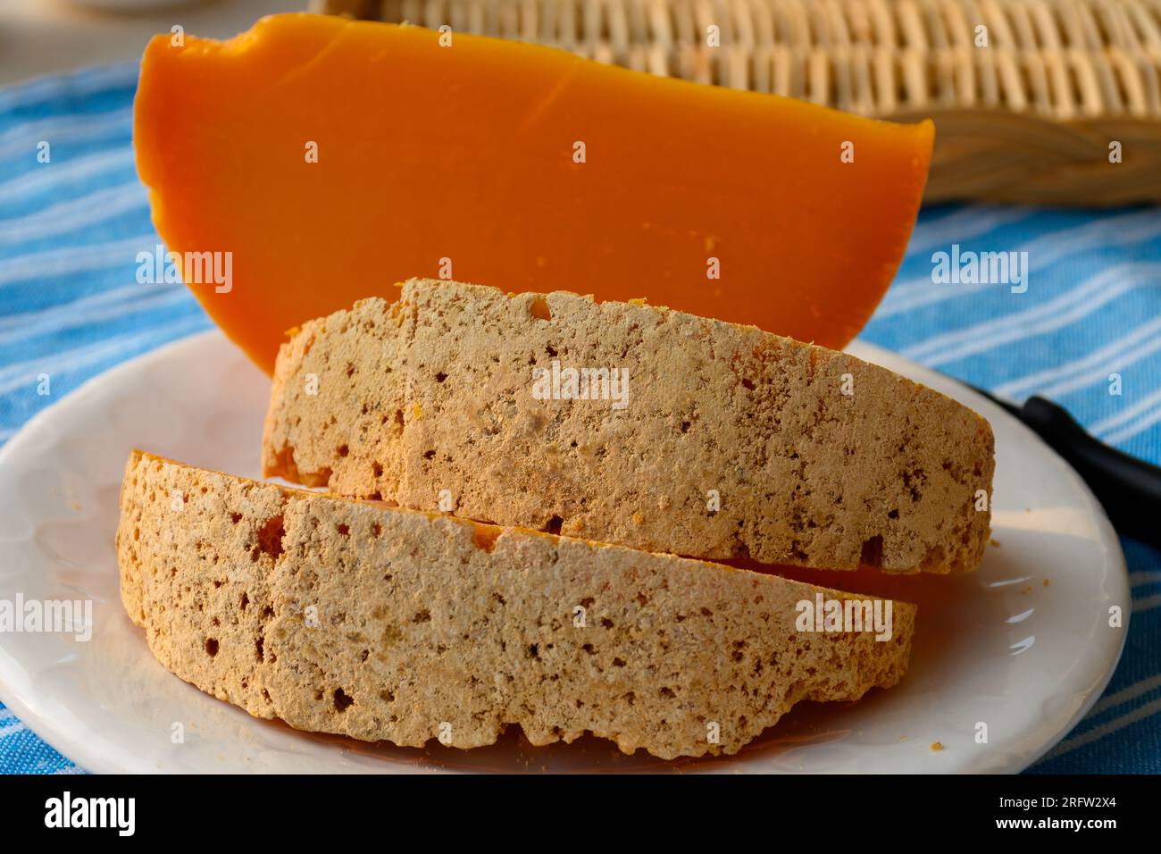 Pieces of native French aged cheese Mimolette, produced in Lille with greyish curst made by ...