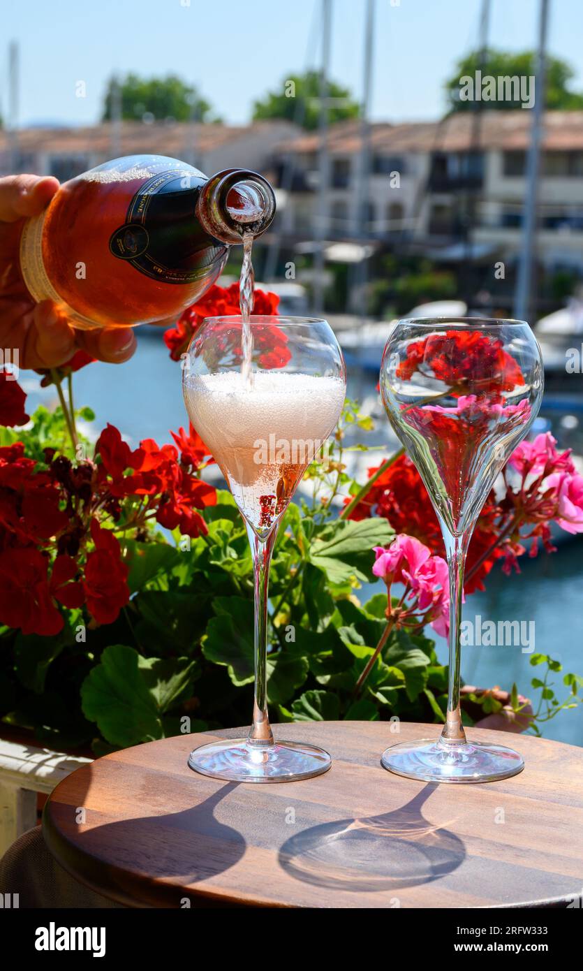 Summer party, drinking of French brut rose champagne sparkling wine in ...