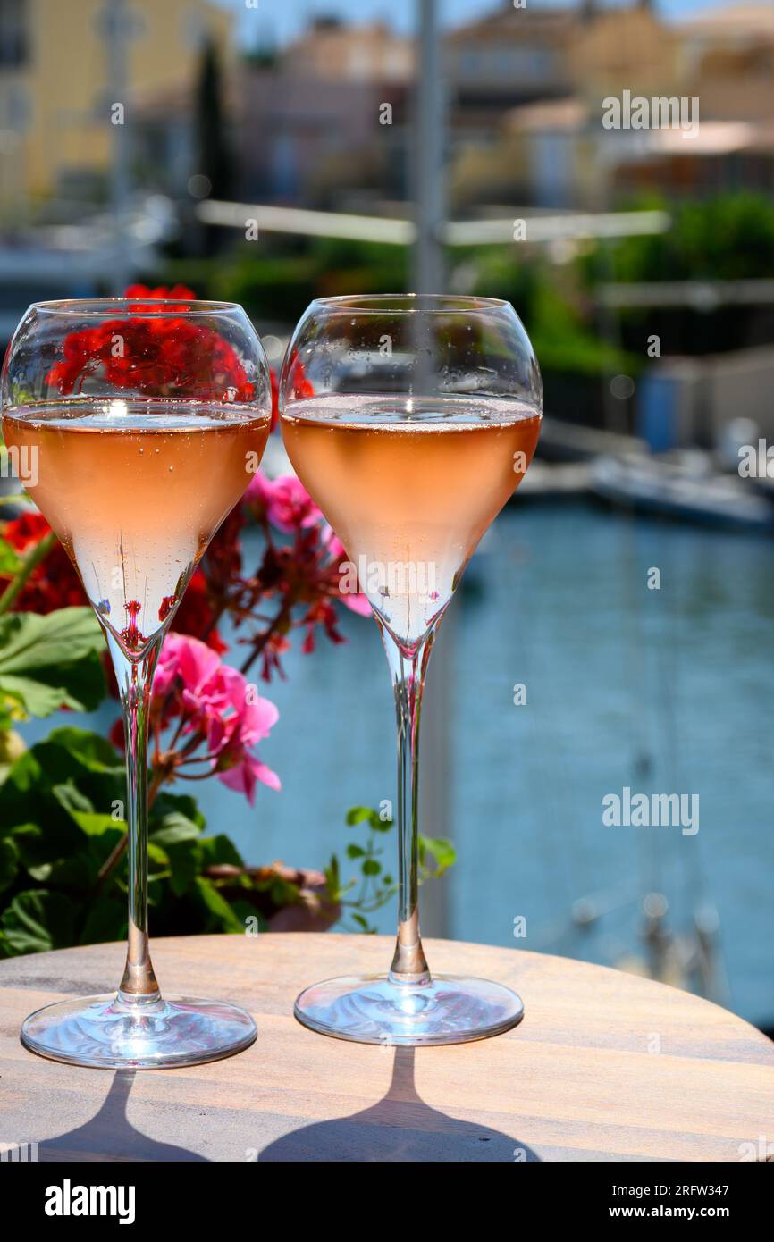 Summer party, drinking of French brut rose champagne sparkling wine in ...