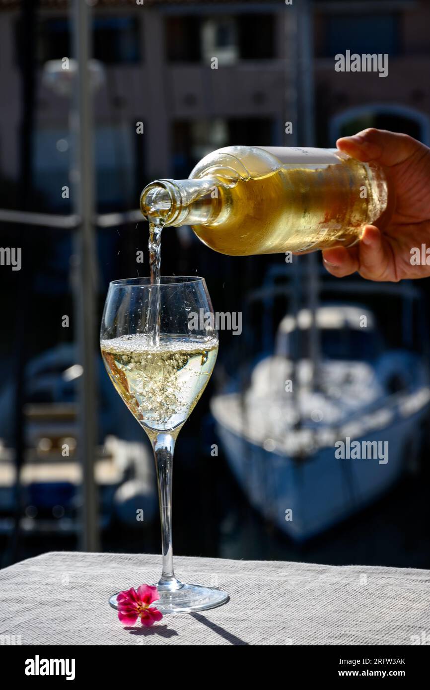 Glass of cold white wine in yacht harbour of Port Grimaud, summer ...