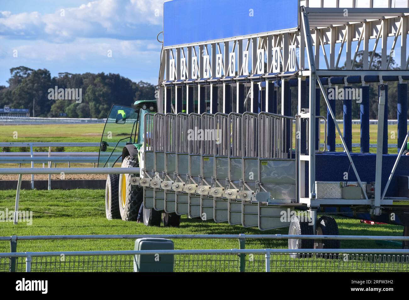 Tractor and start gates for horse races, horse racing barriers Stock ...