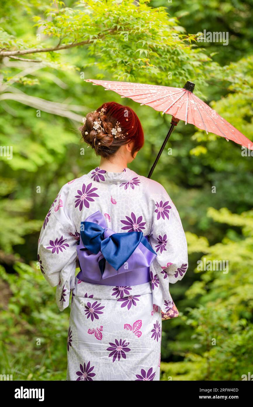 Back view of one woman wearing Japanese yukata summer kimono and ...