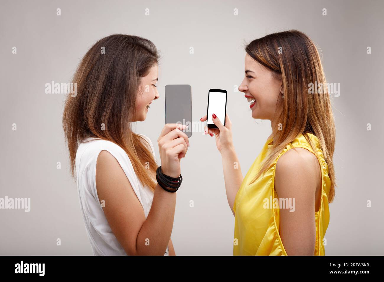 Two young women share amusing, spicy gossip, make fun of others ...