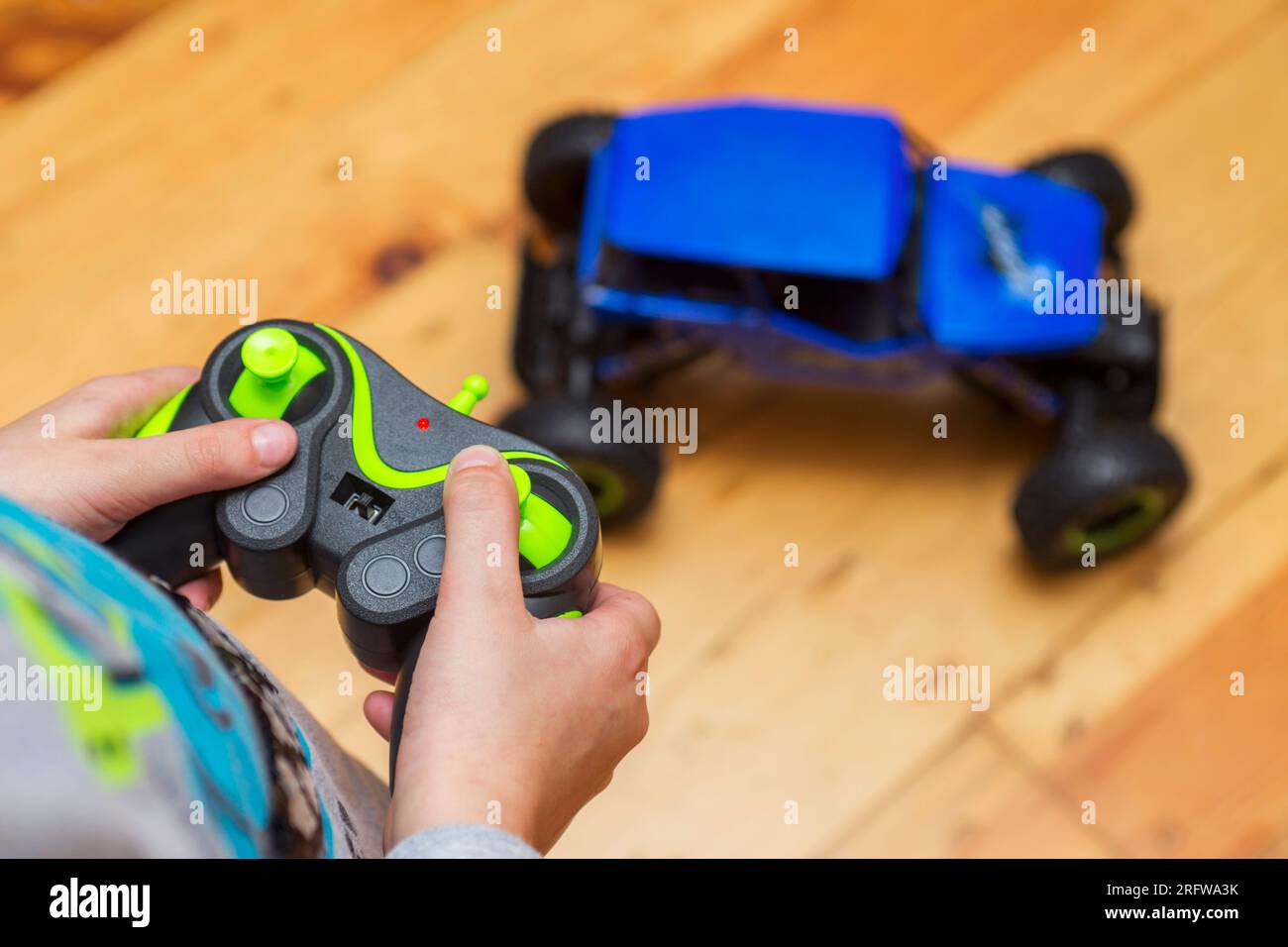 The boy is controling the blue toy car with a remote control Stock ...