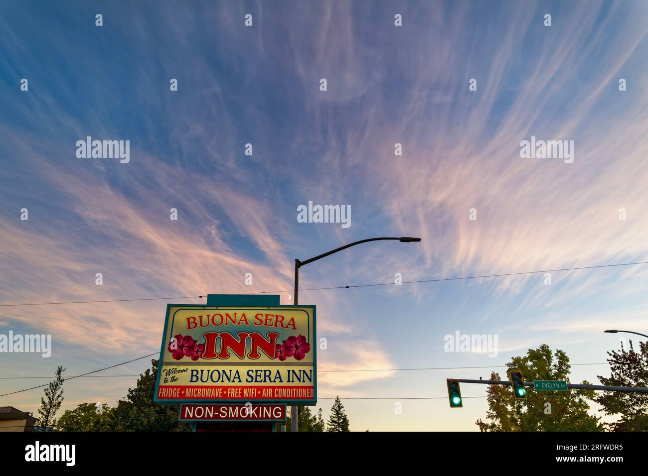 The sign for the Buona Sera Inn illuminated at dusk in Grant's Pass ...