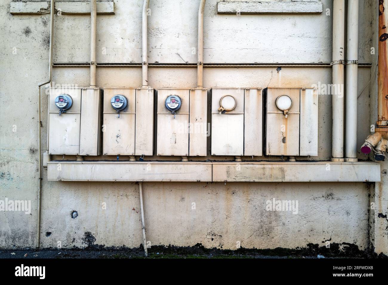 Electric meters line the exterior wall of a building in Grant's Pass ...