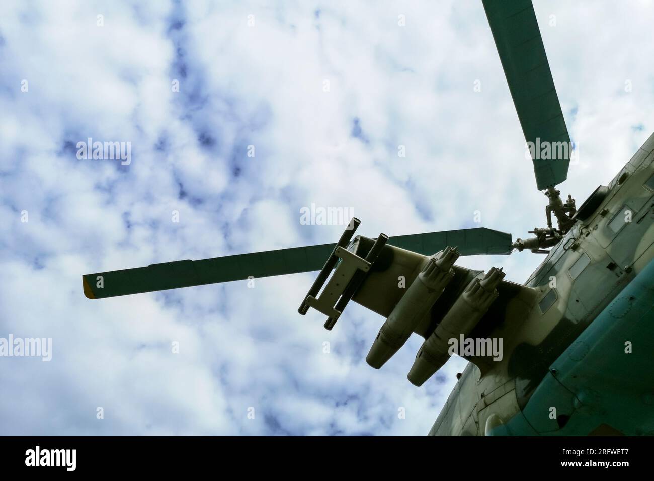 Helicopter flying under sky covered with clouds. Flying military ...
