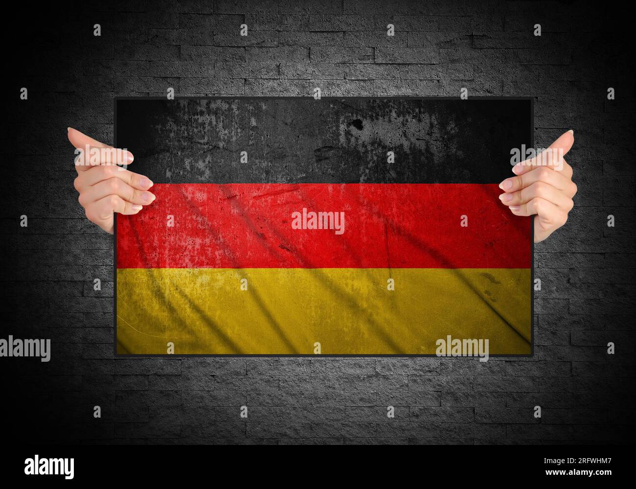 Hand holding german flag on hi-res stock photography and images - Alamy