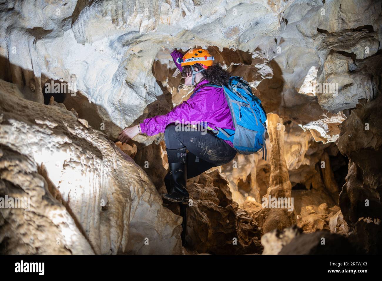 Young woman spelunking inside a cave. Feminism concept. Concept of ...