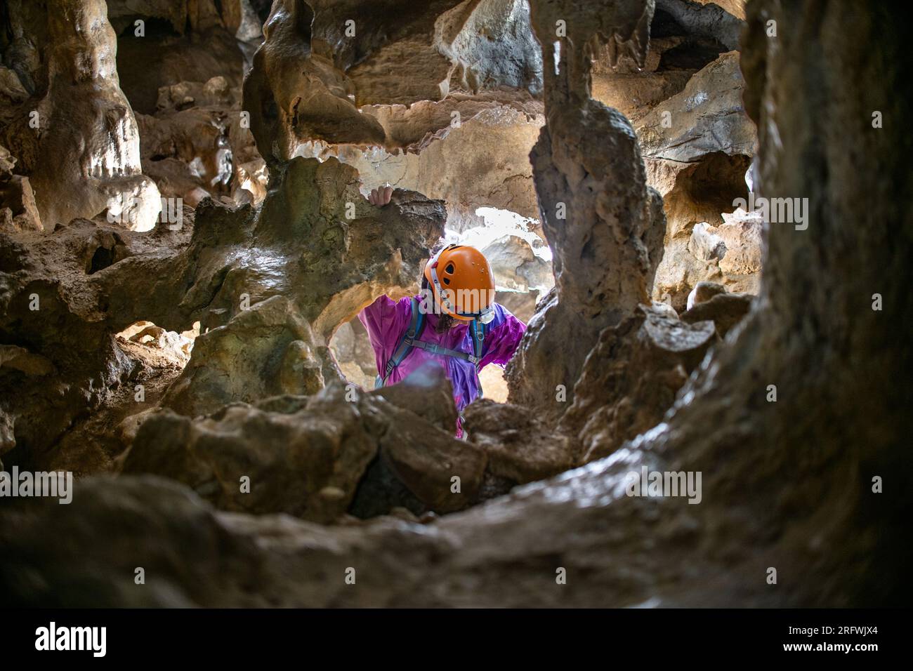 Young woman spelunking inside a cave. Feminism concept. Concept of ...