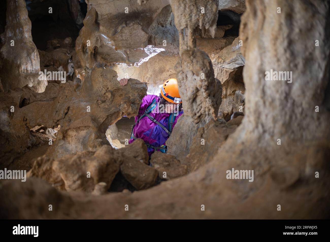 Young woman spelunking inside a cave. Feminism concept. Concept of ...