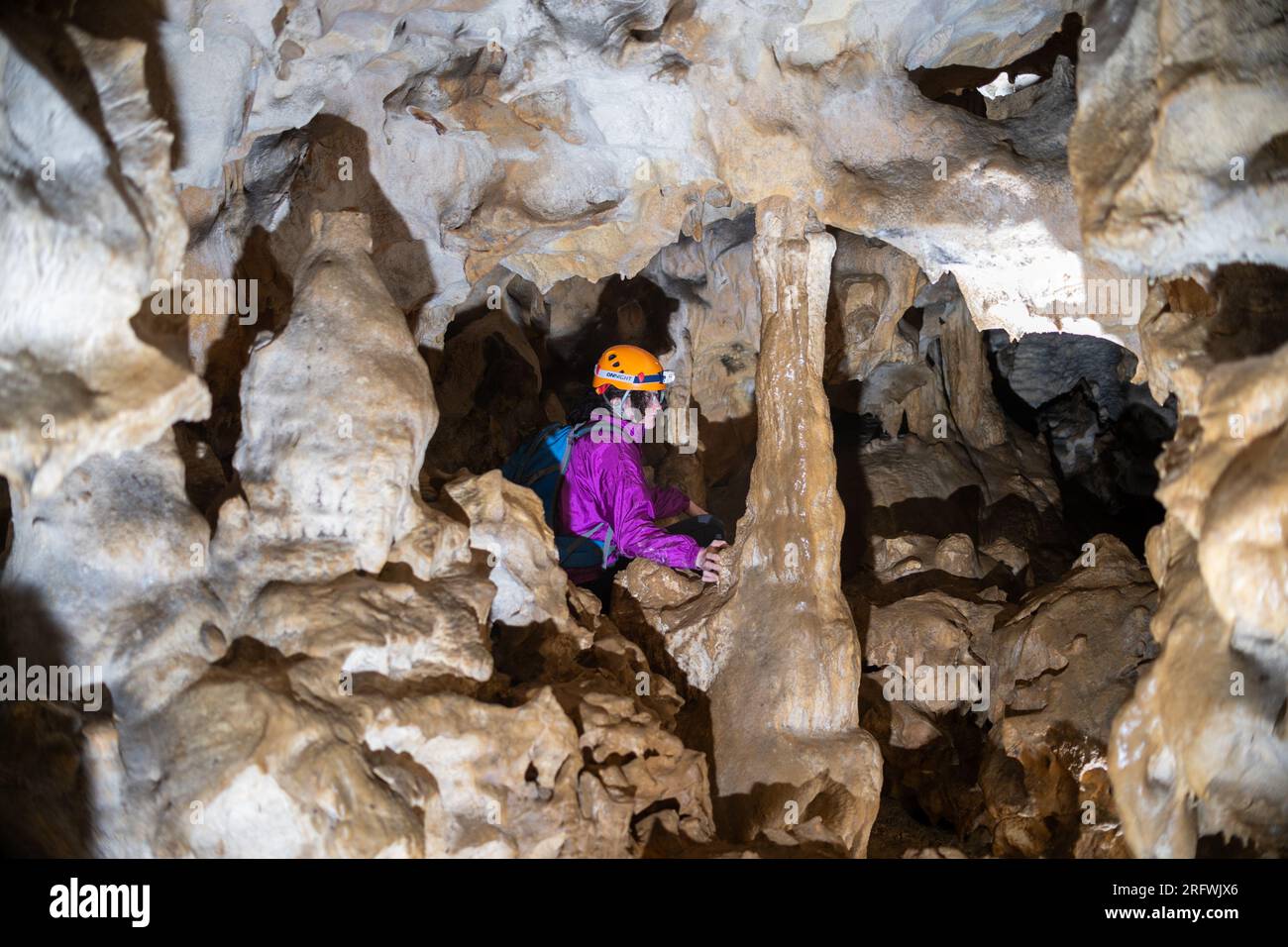 Young woman spelunking inside a cave. Feminism concept. Concept of ...
