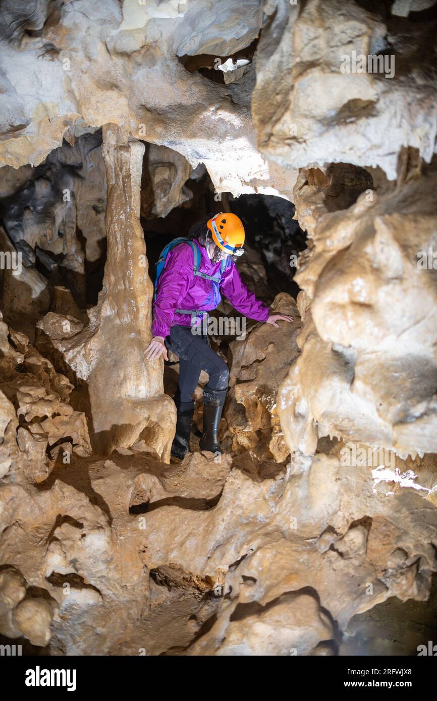 Young woman spelunking inside a cave. Feminism concept. Concept of ...