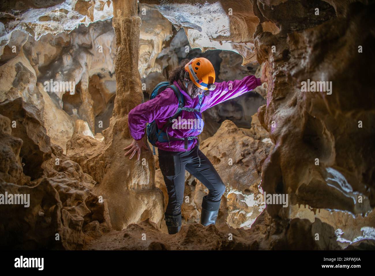 Young woman spelunking inside a cave. Feminism concept. Concept of ...