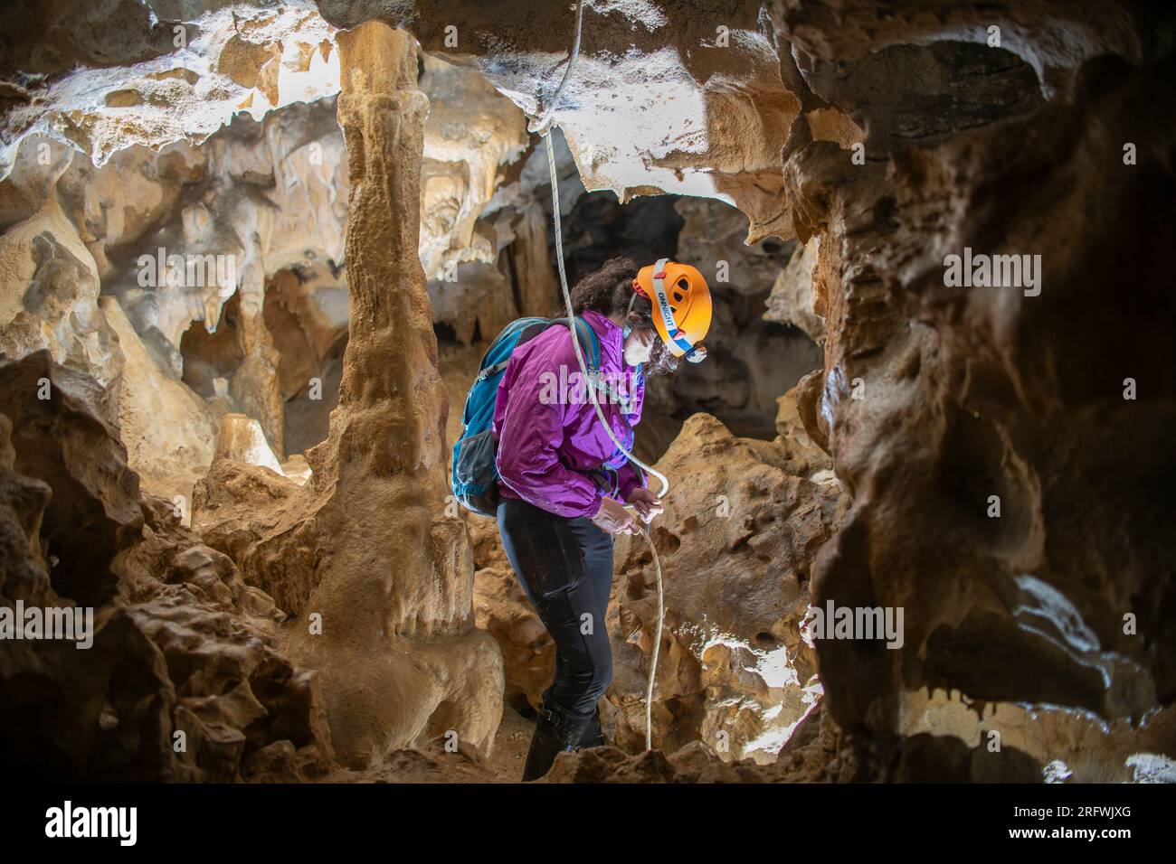 Young woman spelunking inside a cave. Feminism concept. Concept of ...