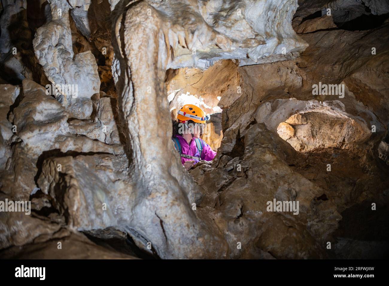 Young woman spelunking inside a cave. Feminism concept. Concept of ...