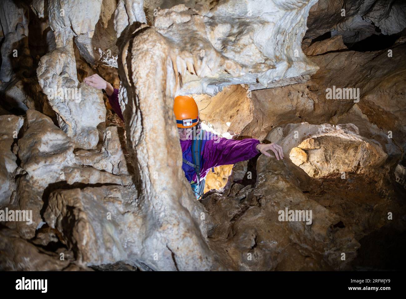 Young woman spelunking inside a cave. Feminism concept. Concept of ...