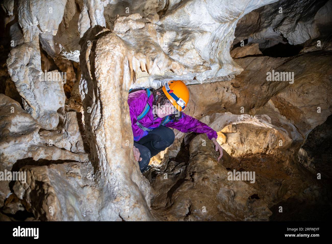 Young woman spelunking inside a cave. Feminism concept. Concept of ...