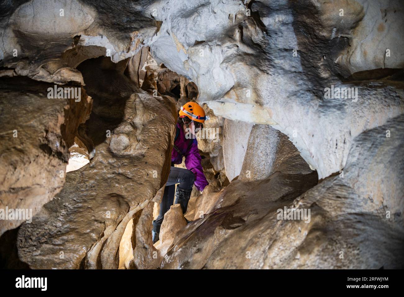 Young woman spelunking inside a cave. Feminism concept. Concept of ...
