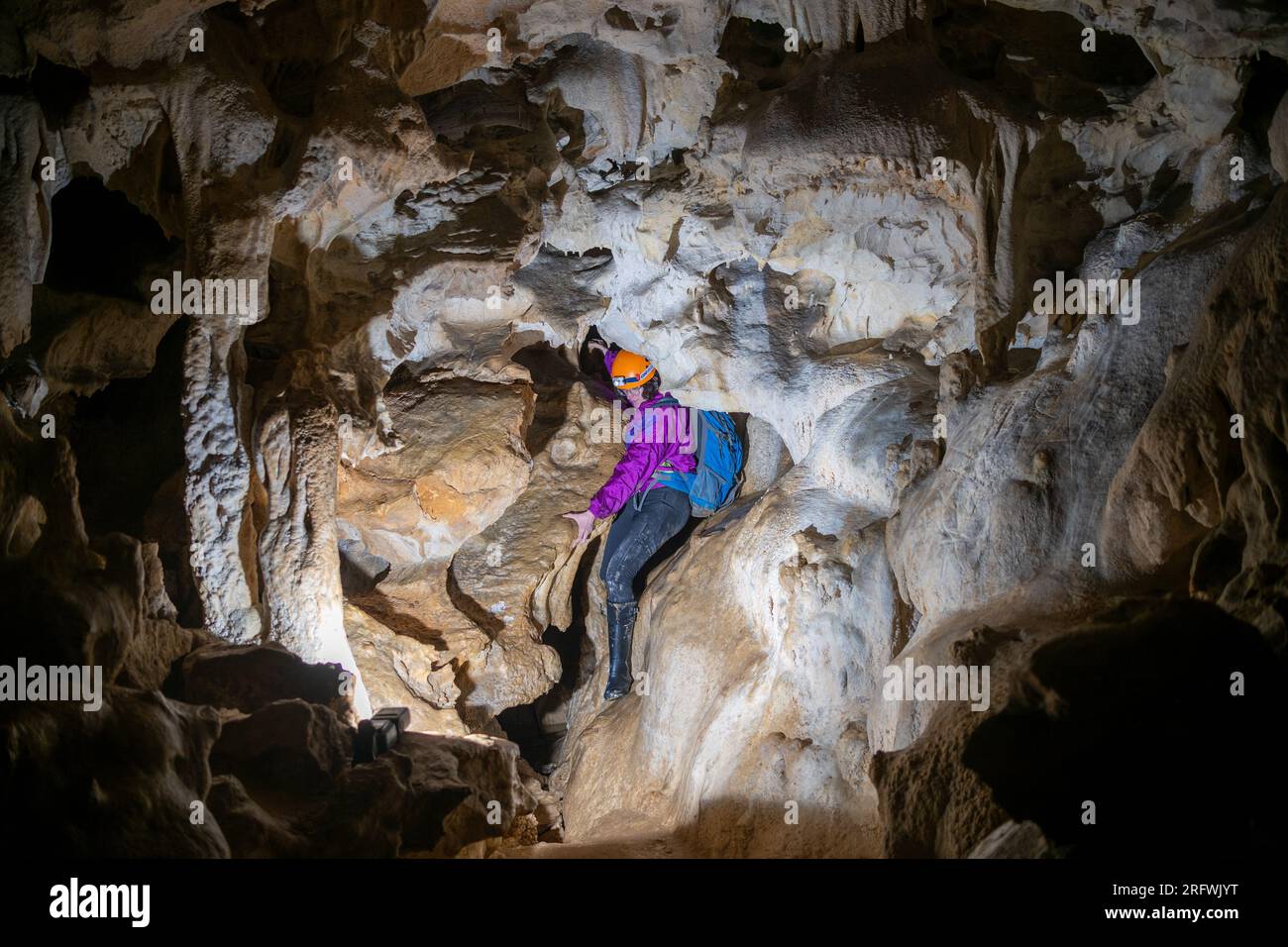 Young woman spelunking inside a cave. Feminism concept. Concept of ...