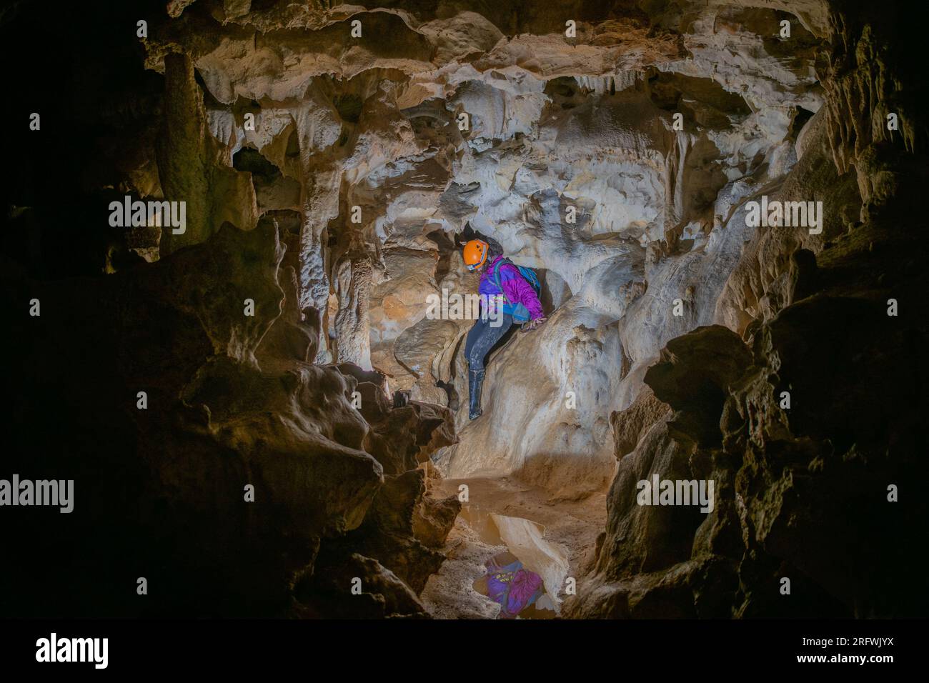 Young woman spelunking inside a cave. Feminism concept. Concept of ...